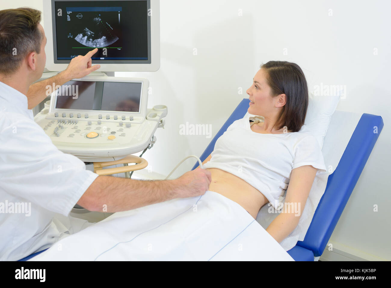 doctor applying gel on belly of woman in hospital Stock Photo - Alamy