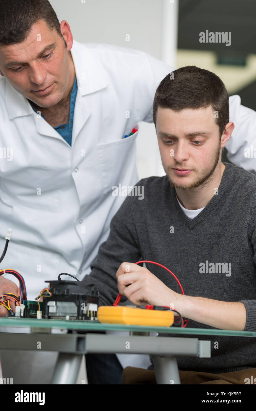 apprentice in electronics doing a voltage test Stock Photo - Alamy