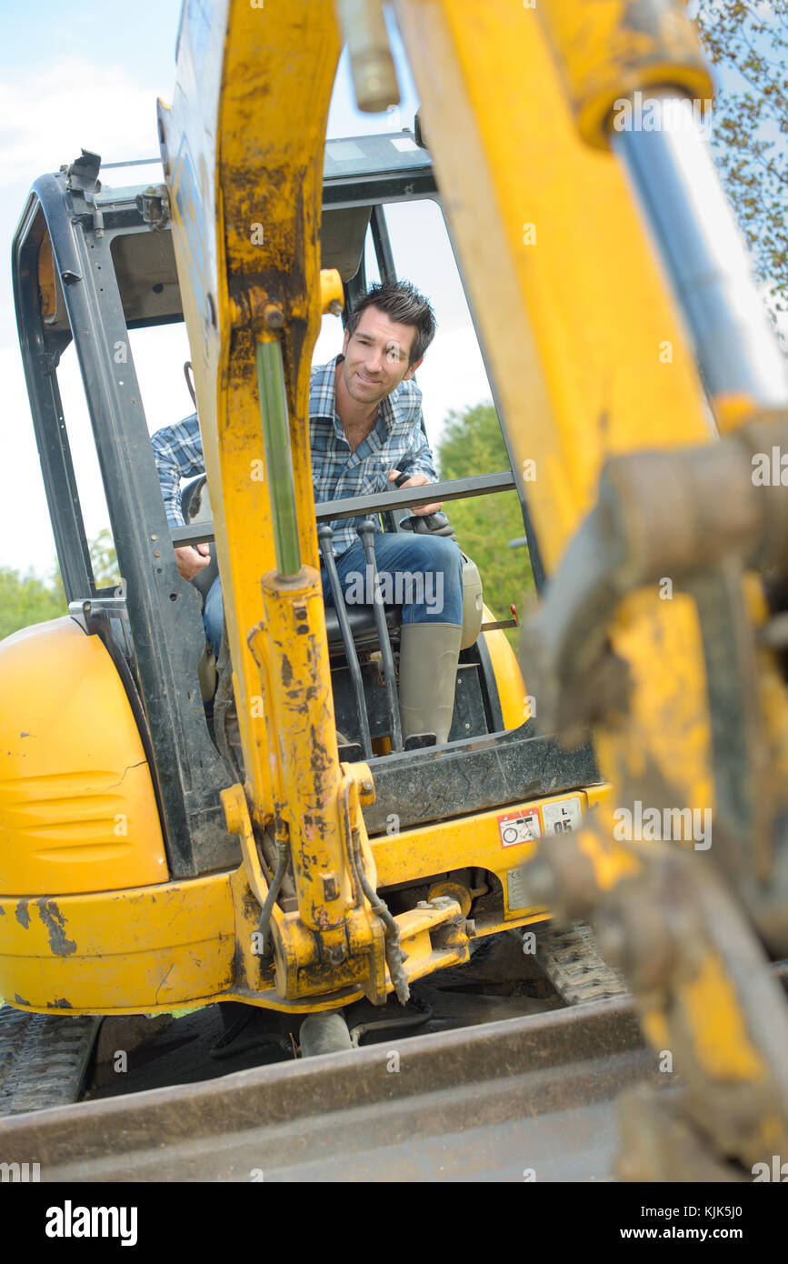 Man operating digger Stock Photo - Alamy