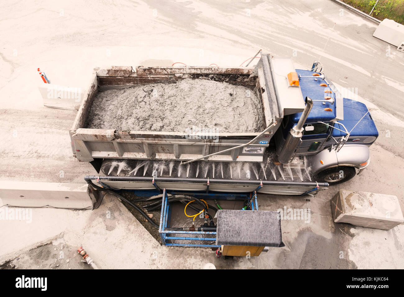 Water rinsing tires of construction trucks hauling cement Stock Photo ...