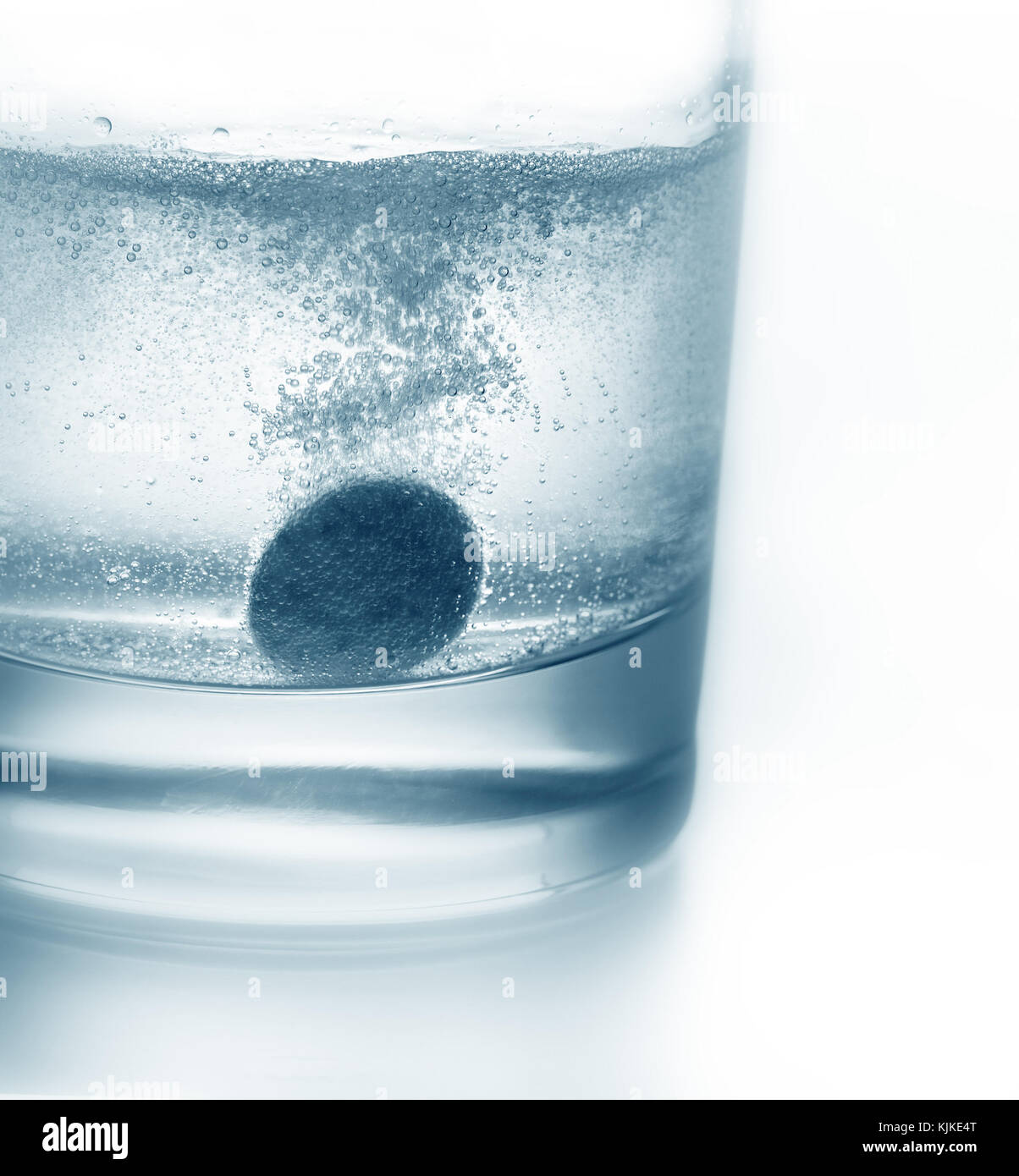 Tablet sinking in water close-up Stock Photo - Alamy