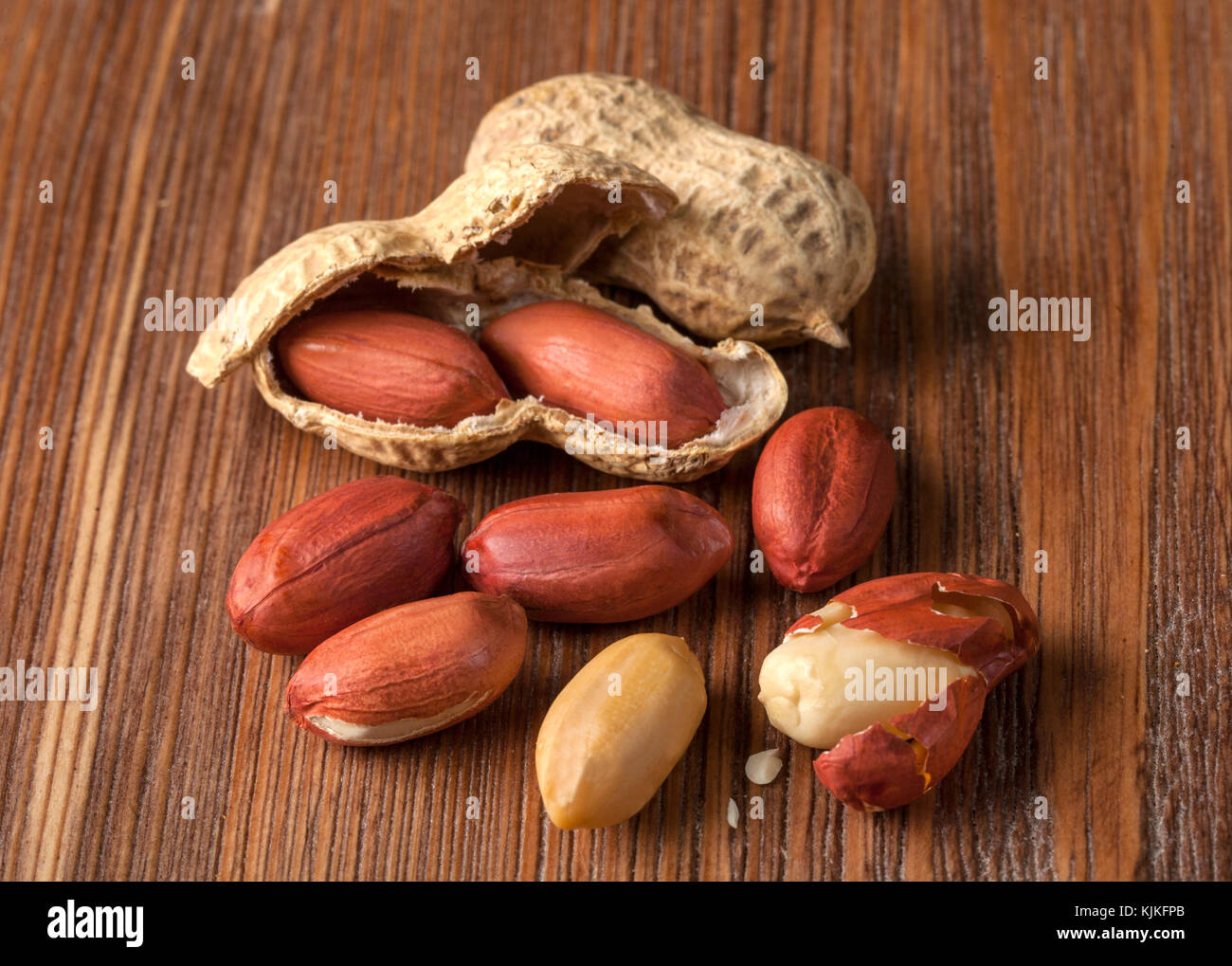 Peeled peanuts on well peanuts in background. Macro image Stock Photo ...