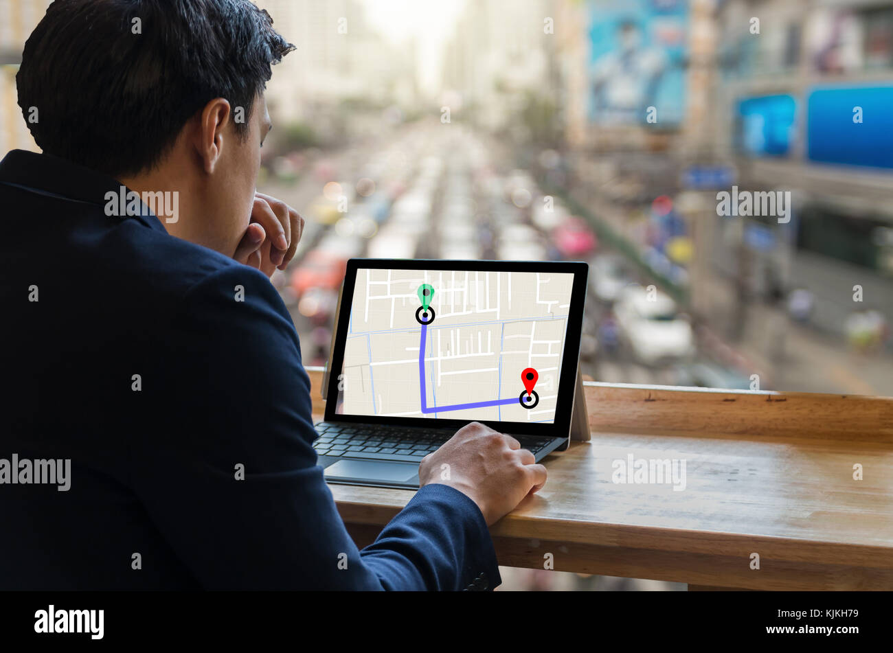Businessman sitting and using computer laptop showing part of navigator ...