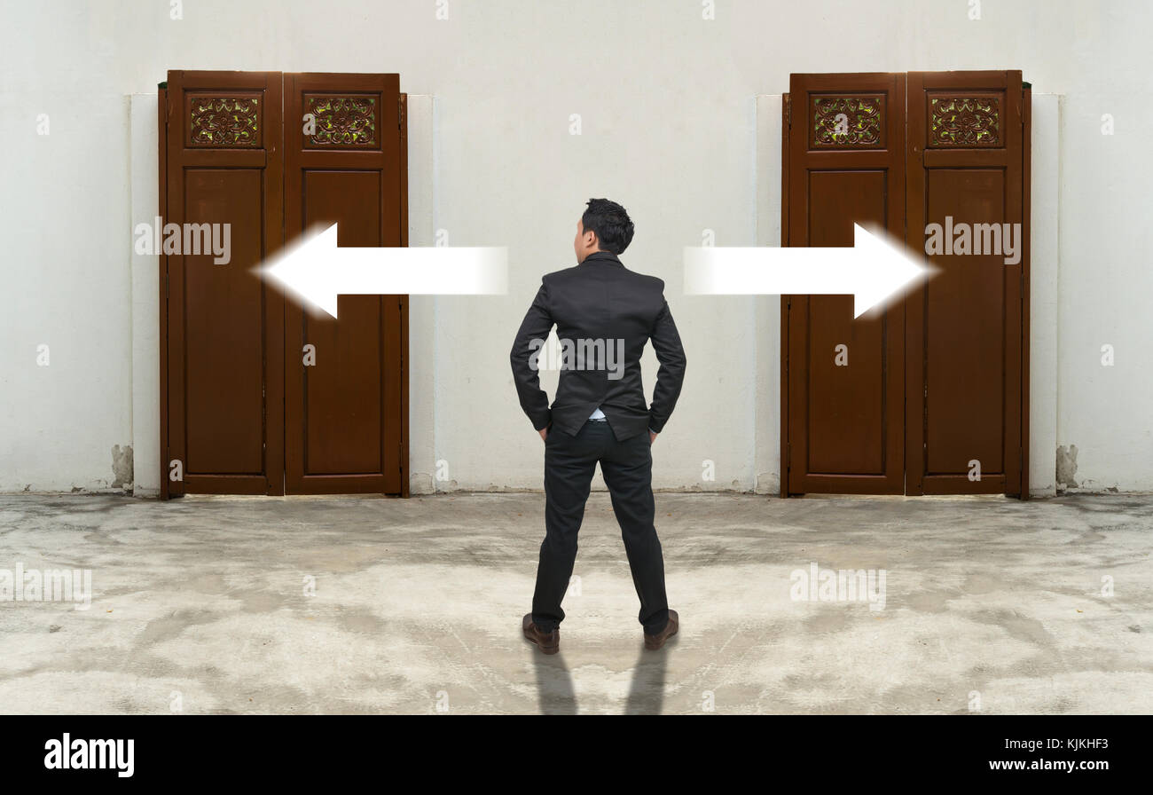 Businessman standing in doubt on the wood doors,thinking the two ... Businessman standing in doubt on the wood doors,thinking the two ...