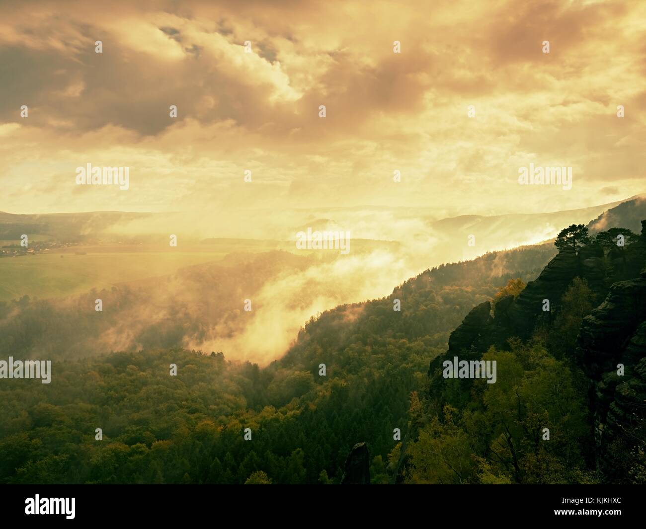 Cold and damp morning in autumn nature. Outlines of forest hills hidden ...