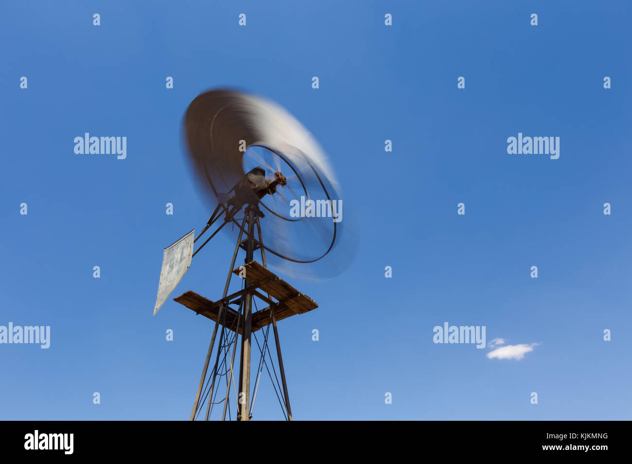 Close up wide angle image of a windmill / windpomp with spinning blades ...