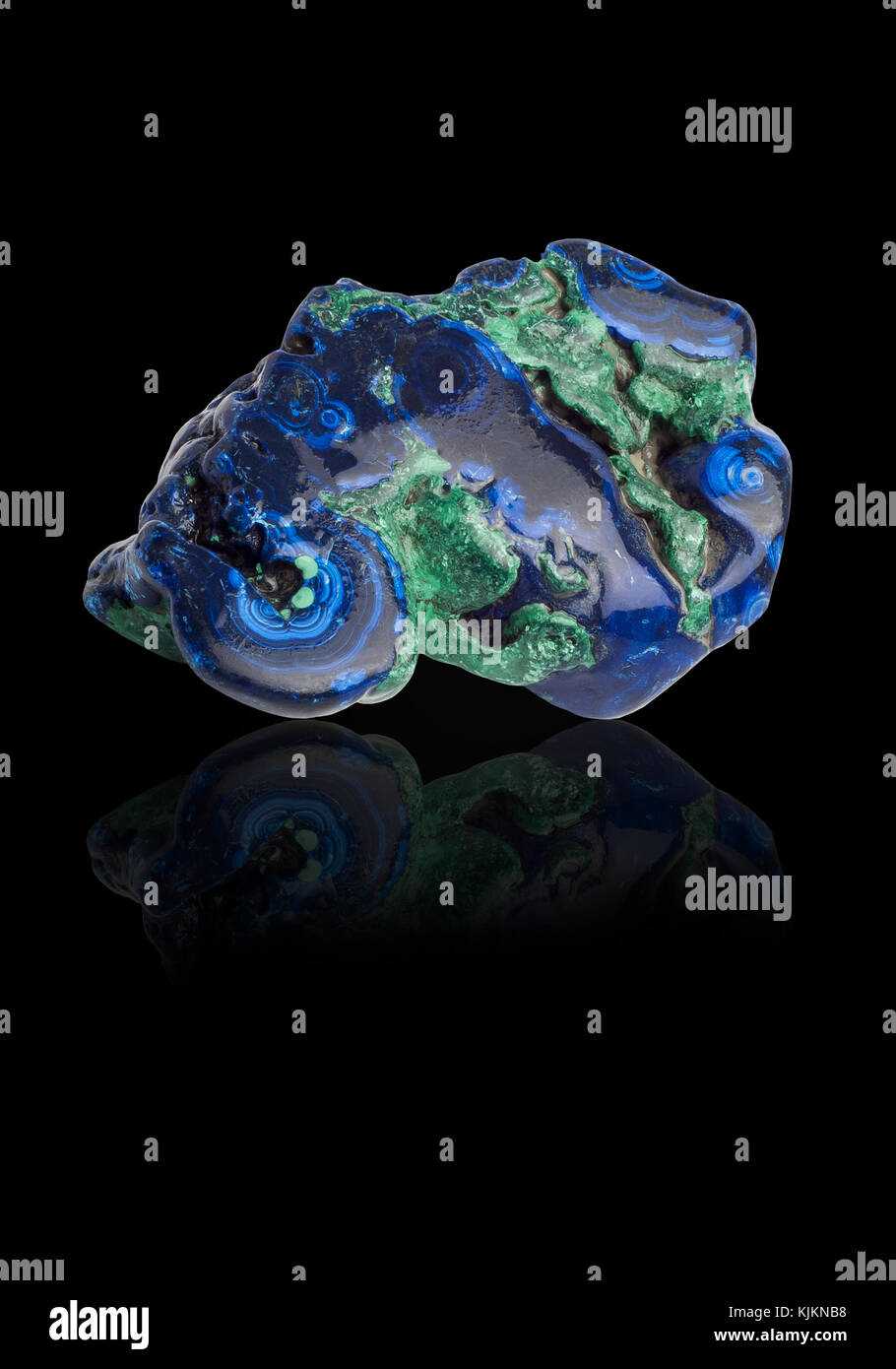 Blue and green Azurite gemstone with ground reflection on the black ...