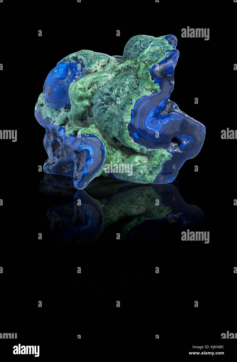 Blue and green Azurite gemstone with ground reflection on the black ...