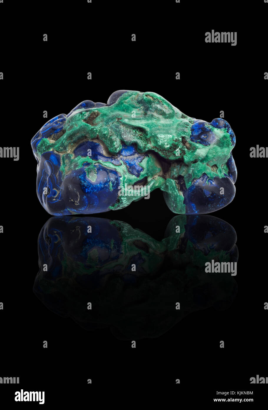 Blue and green Azurite gemstone with ground reflection on the black ...