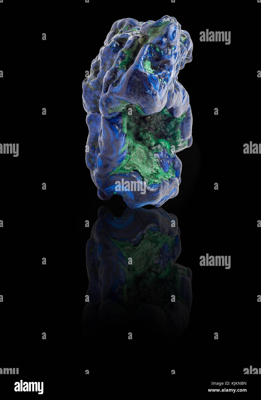 Blue and green Azurite gemstone with ground reflection on the black ...