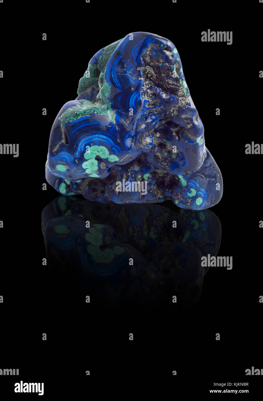 Blue and green Azurite gemstone with ground reflection on the black ...