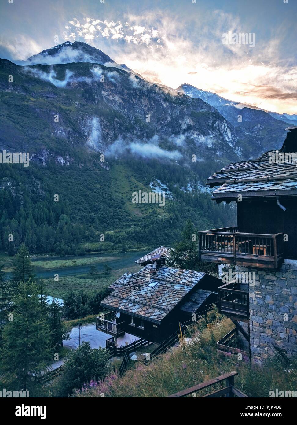 An Alpine sunrise. The sun peaks out over the ridge-line on a crisp ...