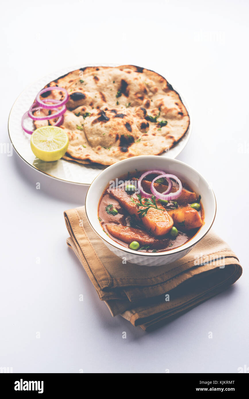 potato curry or aloo masala or alu masala with green peas, served with ...