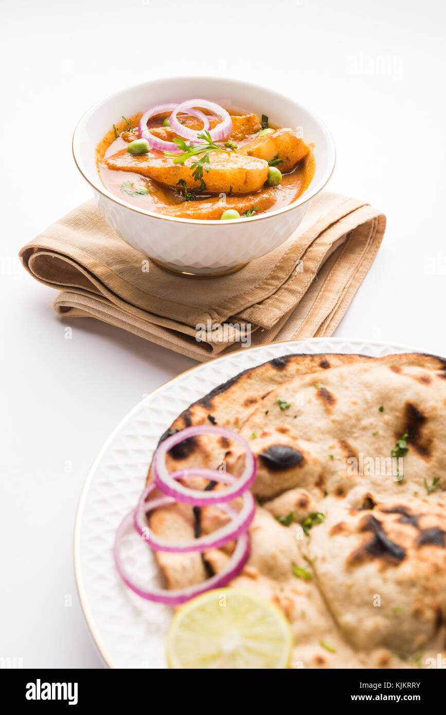 potato curry or aloo masala or alu masala with green peas, served with ...