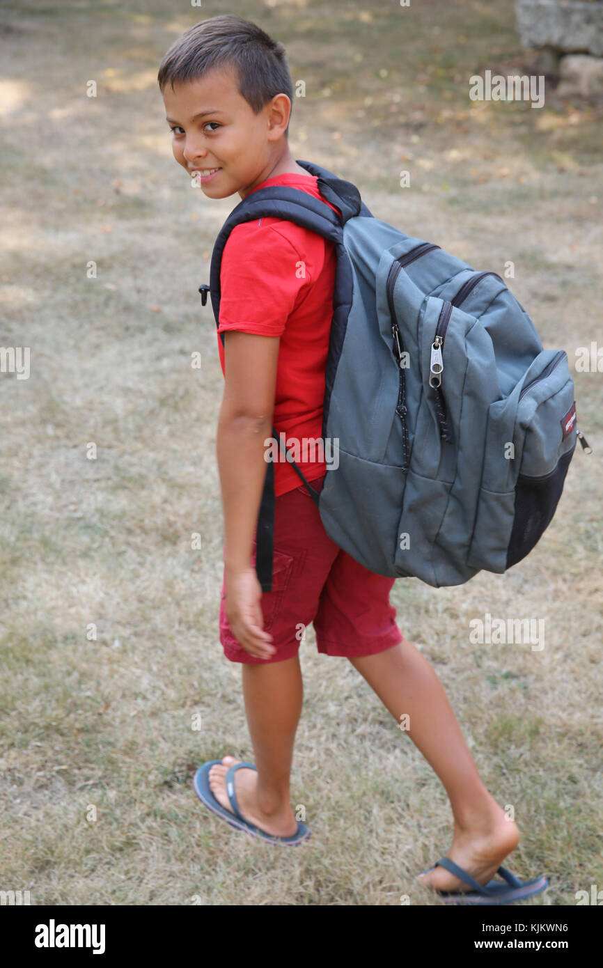 Boy carrying a backpack. France Stock Photo - Alamy