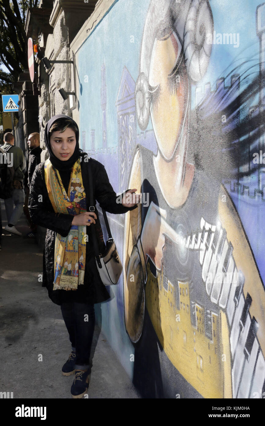 Afghanistan's first female street artist Shamsia Hassani with her mural ...