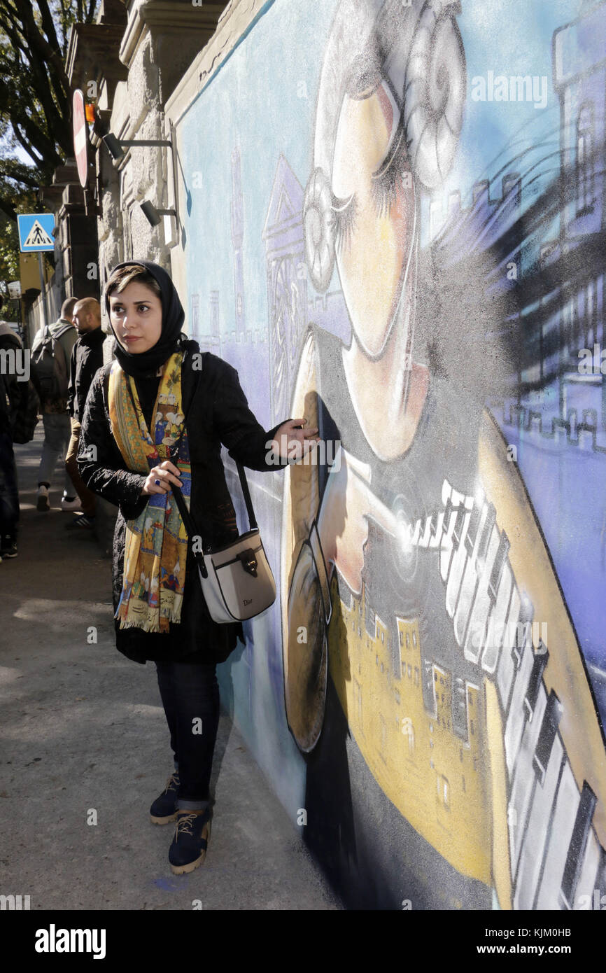 Afghanistan's first female street artist Shamsia Hassani with her mural ...