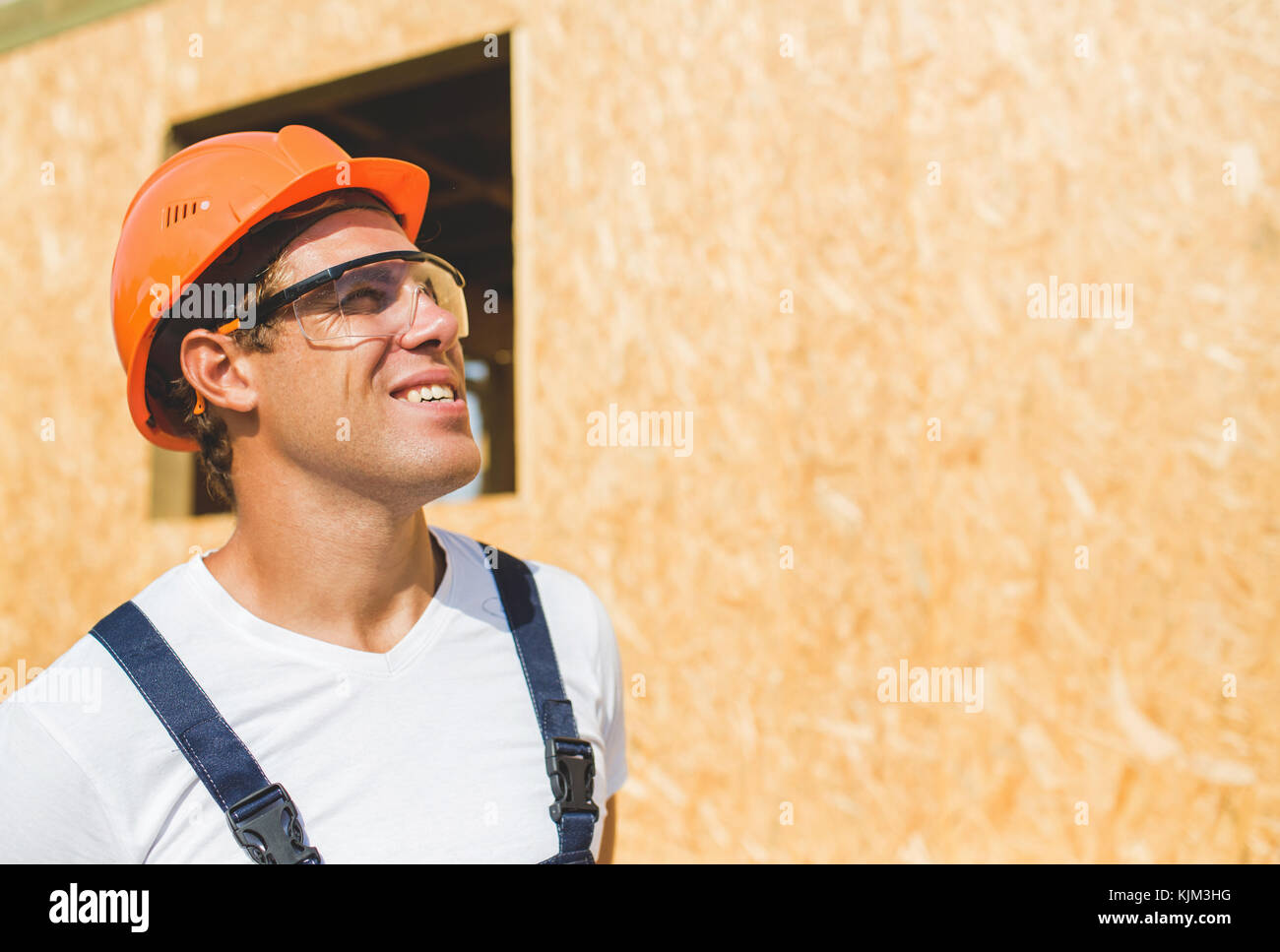 Young man building wooden house. Ecology concept Stock Photo - Alamy