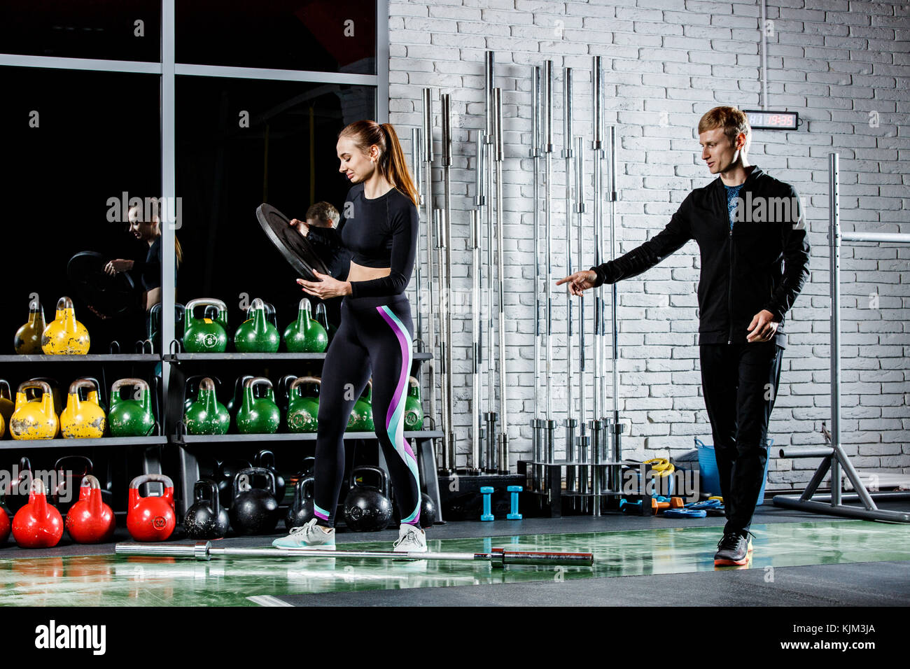 the young girl is getting ready for the exercise with the trainer Stock ...