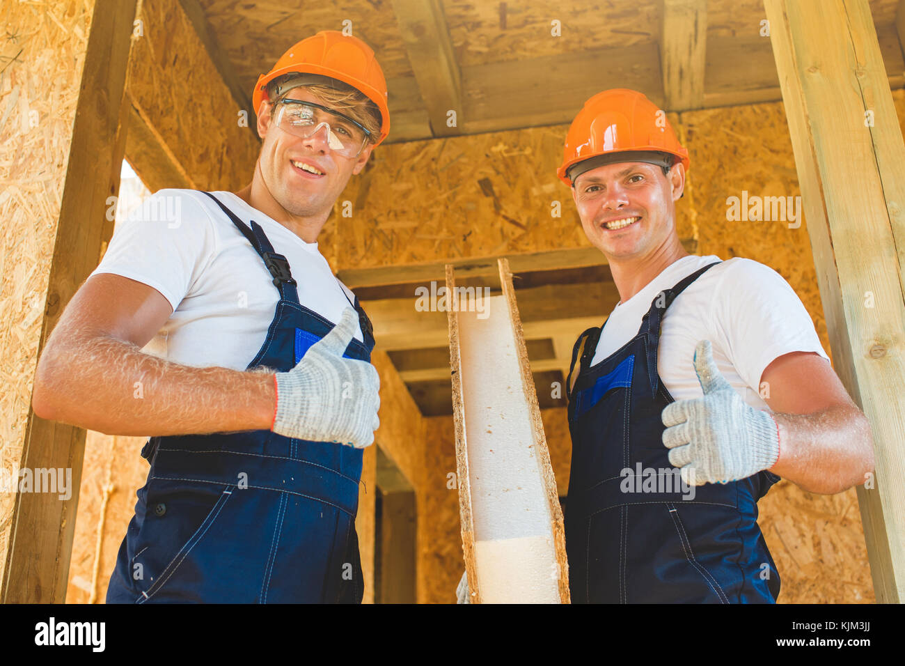 Two young man building wooden house. Ecology concept Stock Photo - Alamy