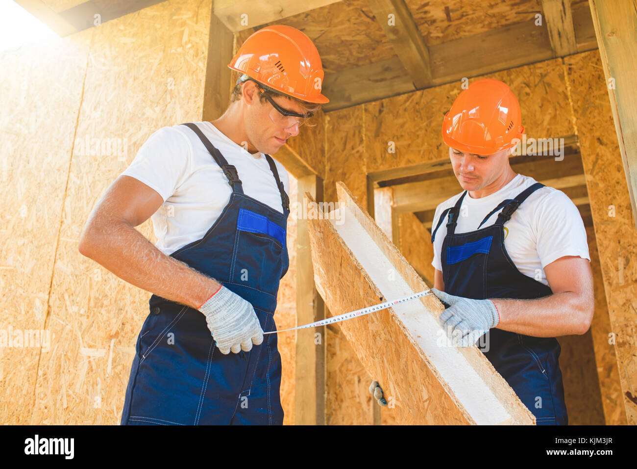 Two young man building wooden house. Ecology concept Stock Photo - Alamy