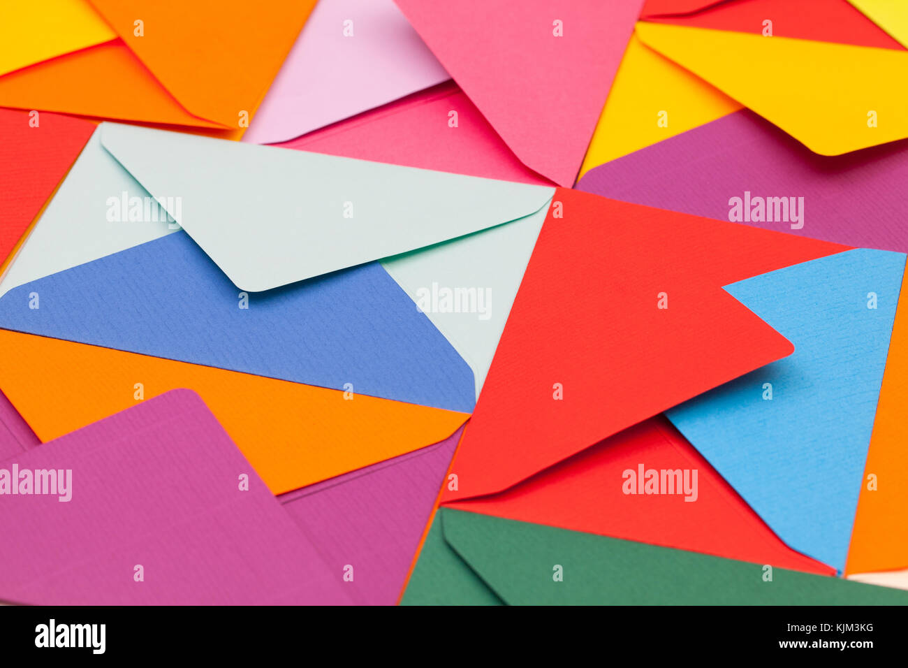 Different colored envelopes on the table Stock Photo - Alamy