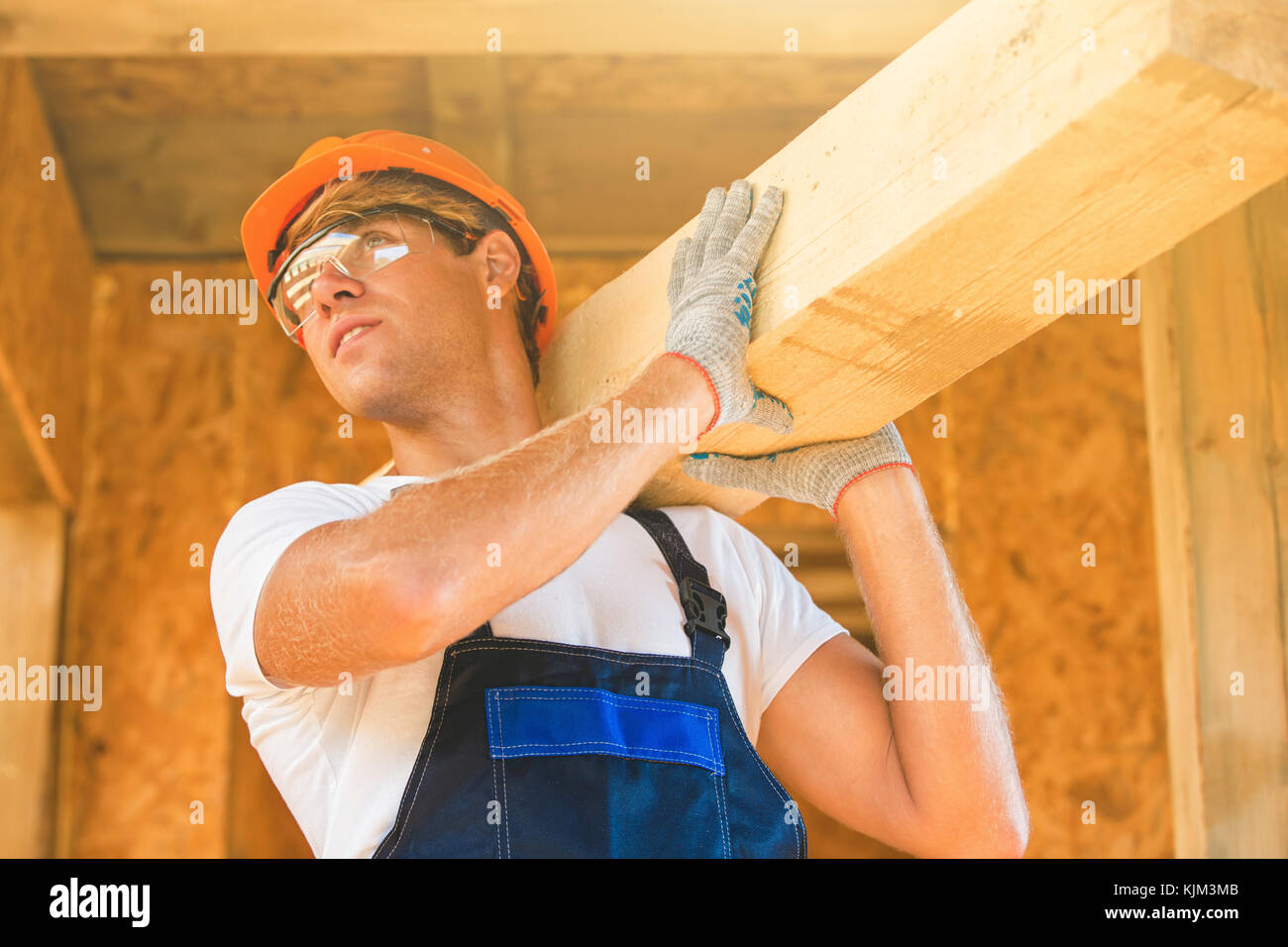 Young man building wooden house. Ecology concept Stock Photo - Alamy