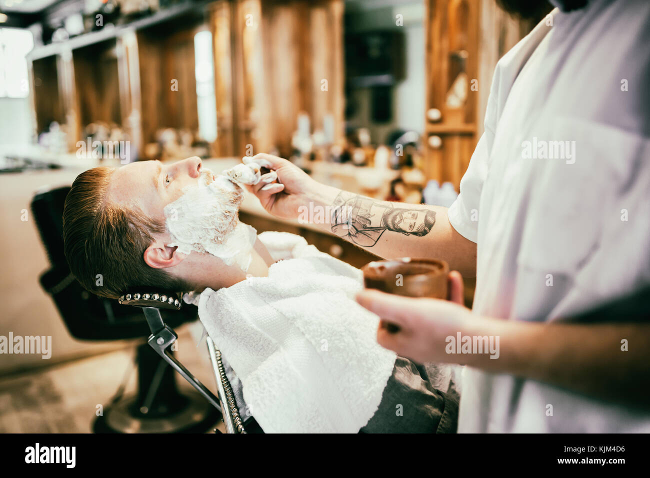 Male receiving hair beard treatment Stock Photo - Alamy