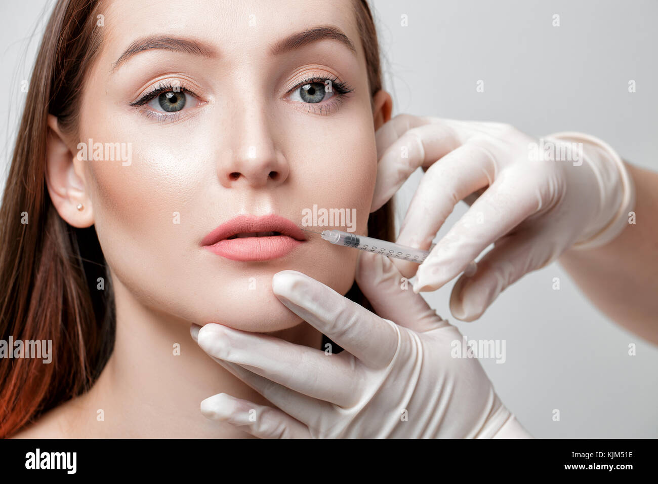 woman getting injection on lips Stock Photo - Alamy