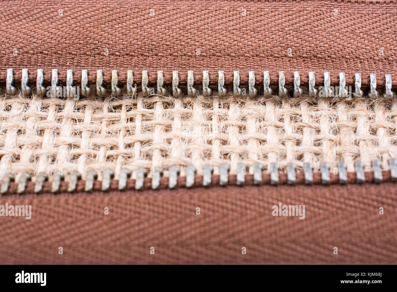 Parts of the brown color zipper on linen canvas background Stock Photo ...