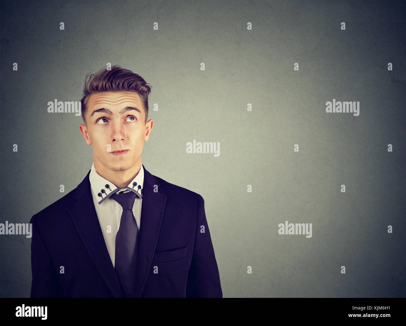 Thinking perplexed man wondering looking up solving a problem isolated ...