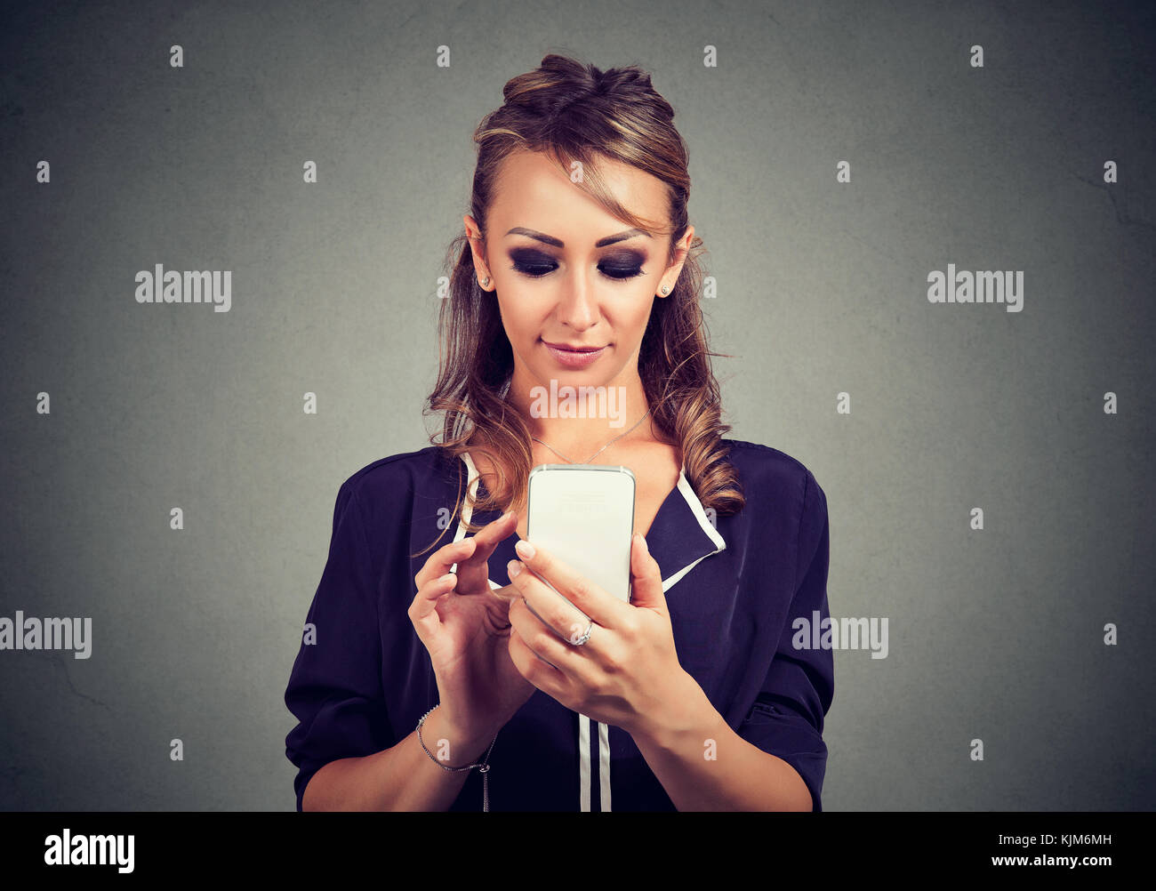 Young smiling woman using a mobile phone Stock Photo - Alamy