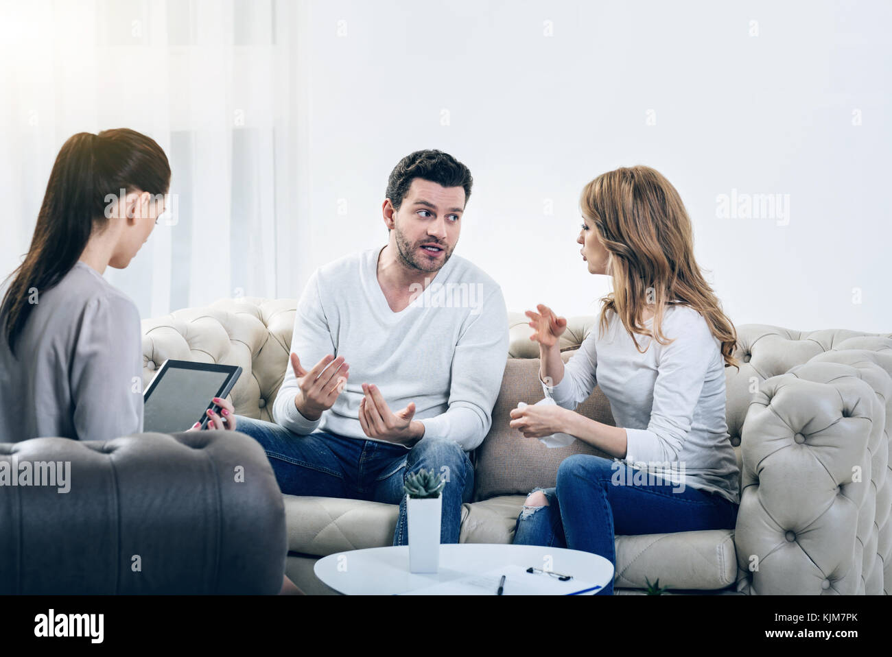 Cheerless unhappy couple having a quarrel Stock Photo - Alamy