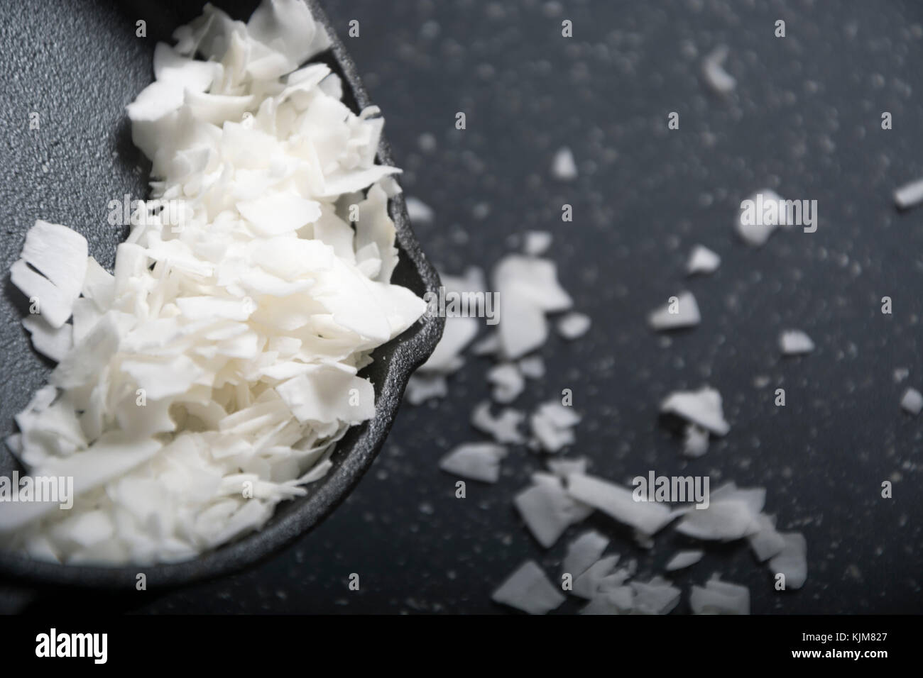 Fresh coconut flakes or white chocolate chip isolated on dark ...