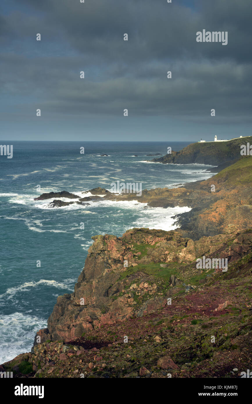 the coastal rocks and rough sea on the coastline near pentire head ...