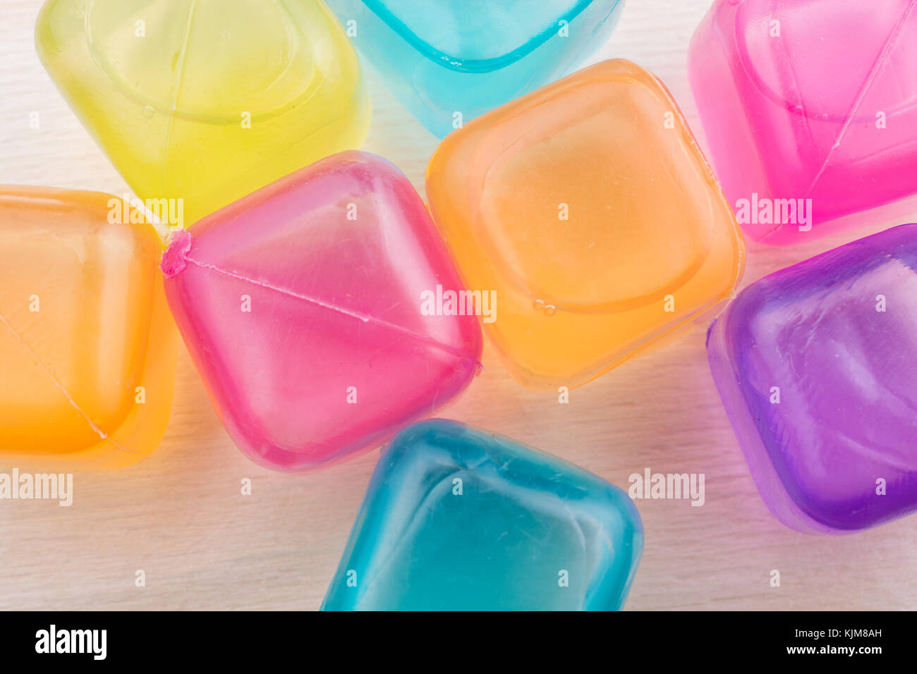 Fake colorful ice cubes on a brown background Stock Photo - Alamy