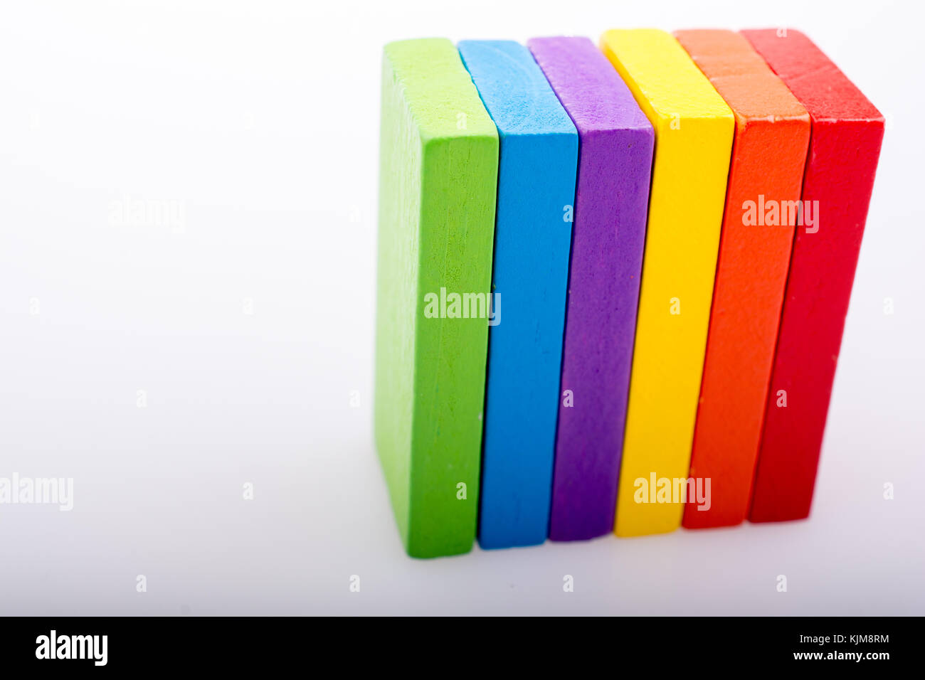 Colorful Domino Blocks in a line on a white background Stock Photo - Alamy