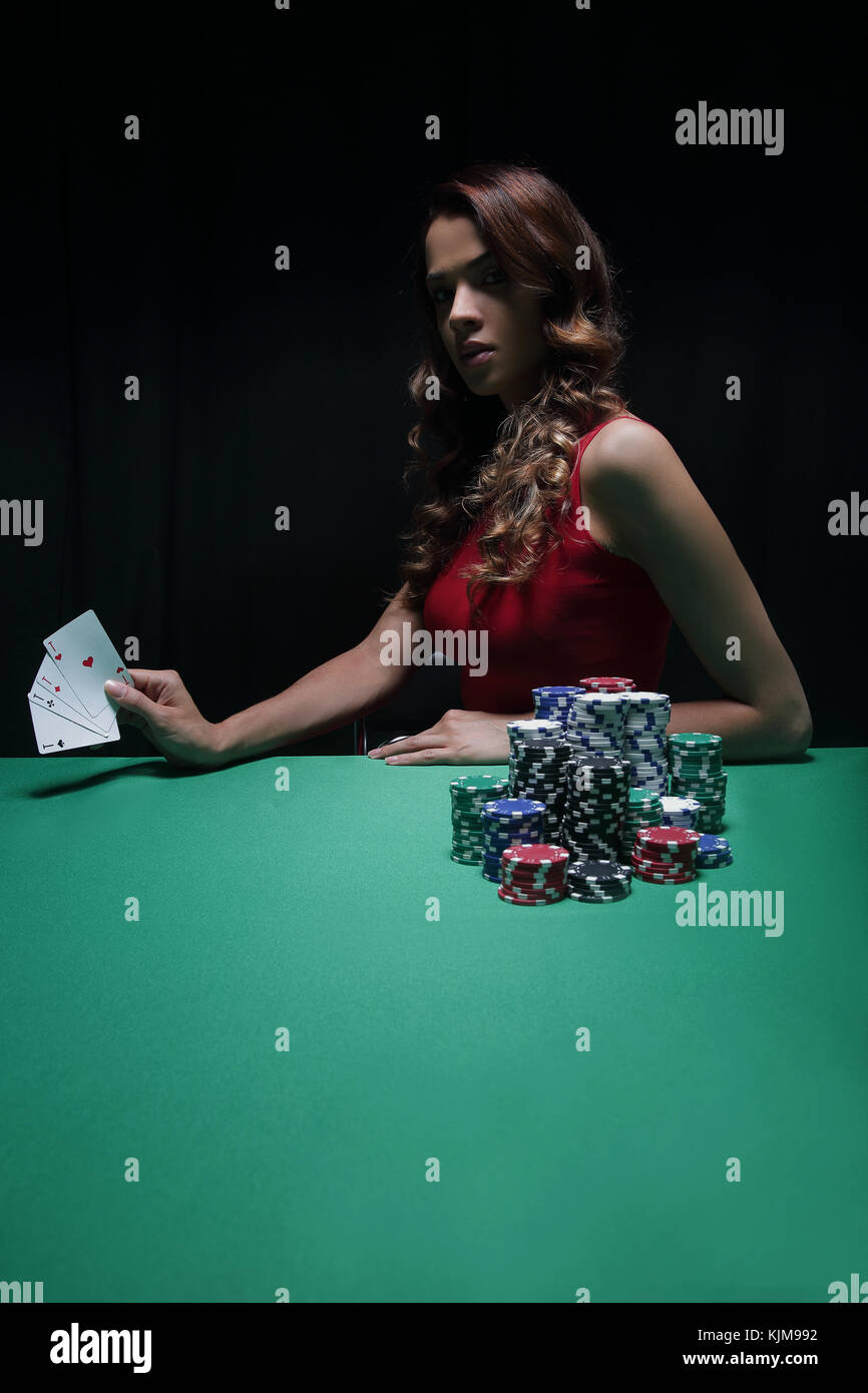pretty young woman gambling on green table Stock Photo - Alamy