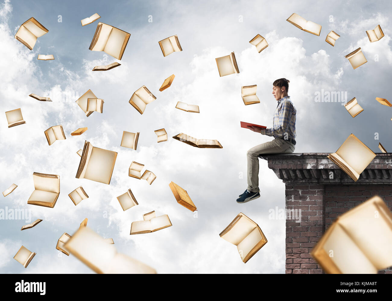 Man reading book and many of them flying in air Stock Photo - Alamy