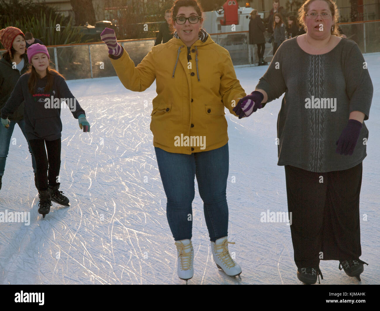 Holding hands while ice skating on a rink in Brighton Stock Photo - Alamy