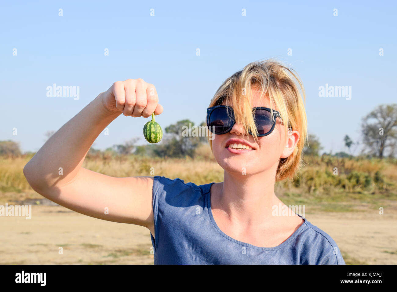 Girl with a small watermelon in her hand. The embryo of watermelon ...