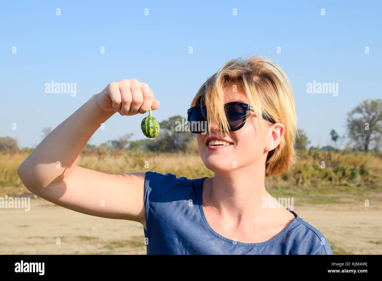 Girl with a small watermelon in her hand. The embryo of watermelon ...