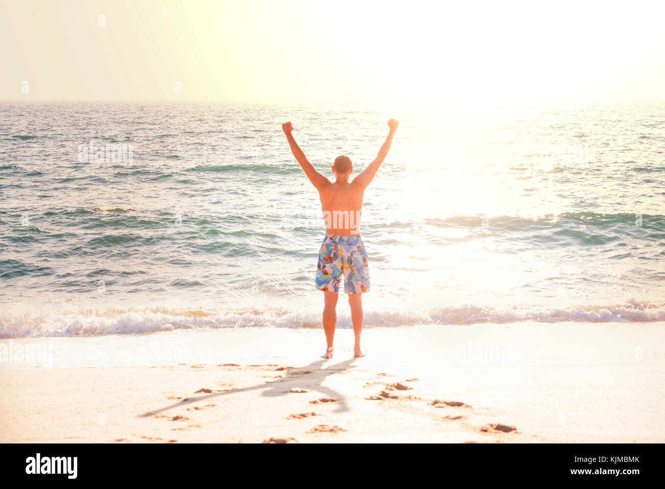 Happy man on beach Stock Photo - Alamy
