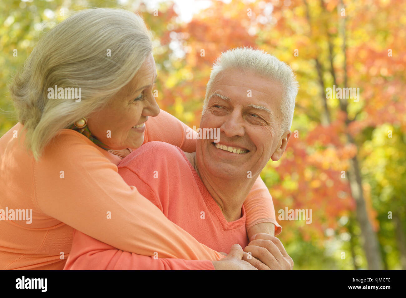 senior couple hugging in the park Stock Photo - Alamy