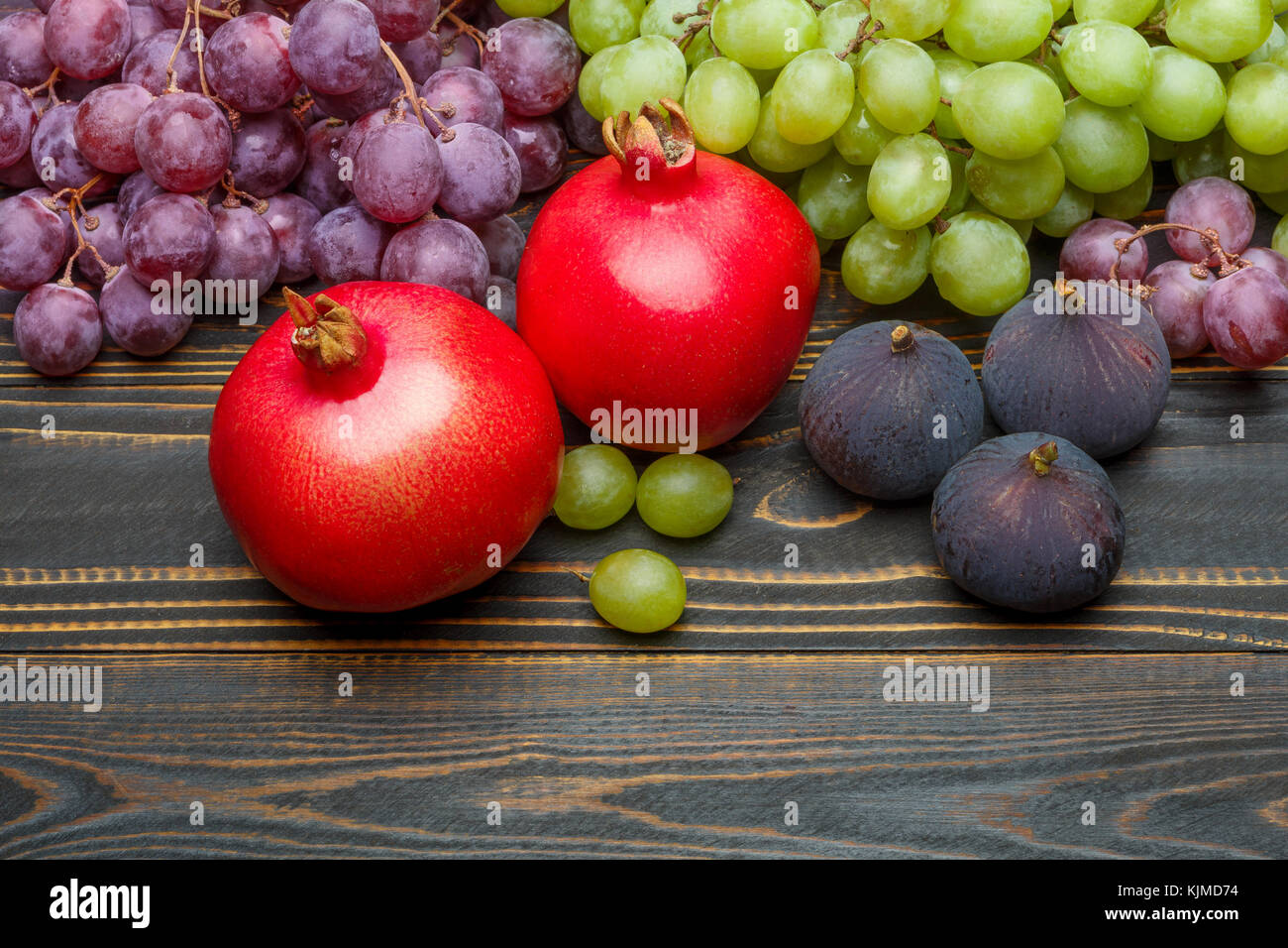 Lots of different fruits on wooden background Stock Photo - Alamy
