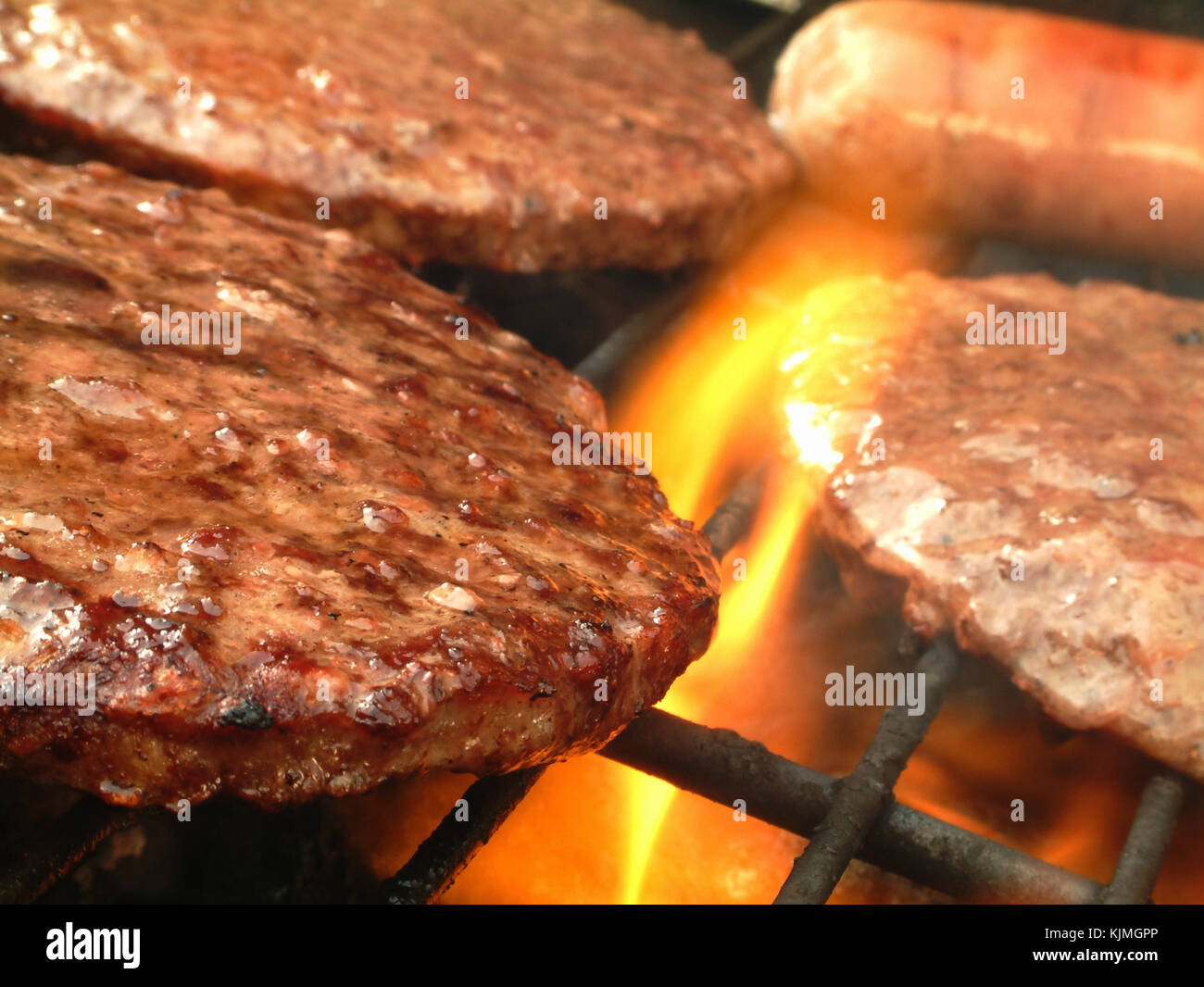 burgers cooking on barbecue Stock Photo - Alamy