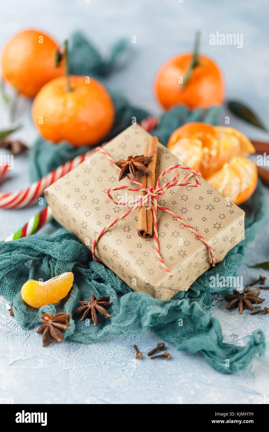 Fresh mandarins with leaves, candy canes, gift boxes in kraft paper and ...
