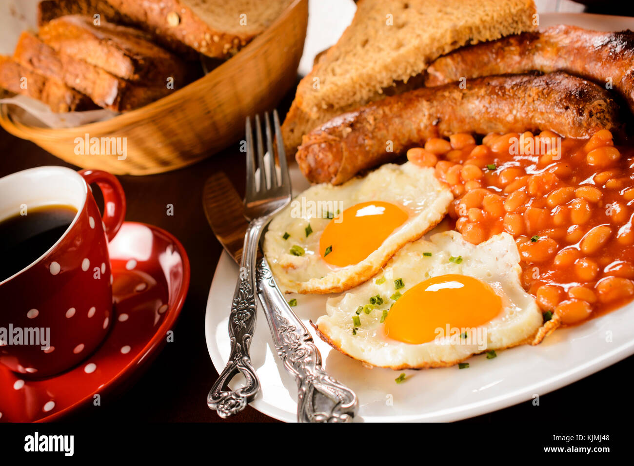 Full English breakfast in the plate.Selective focus on the front yolk ...