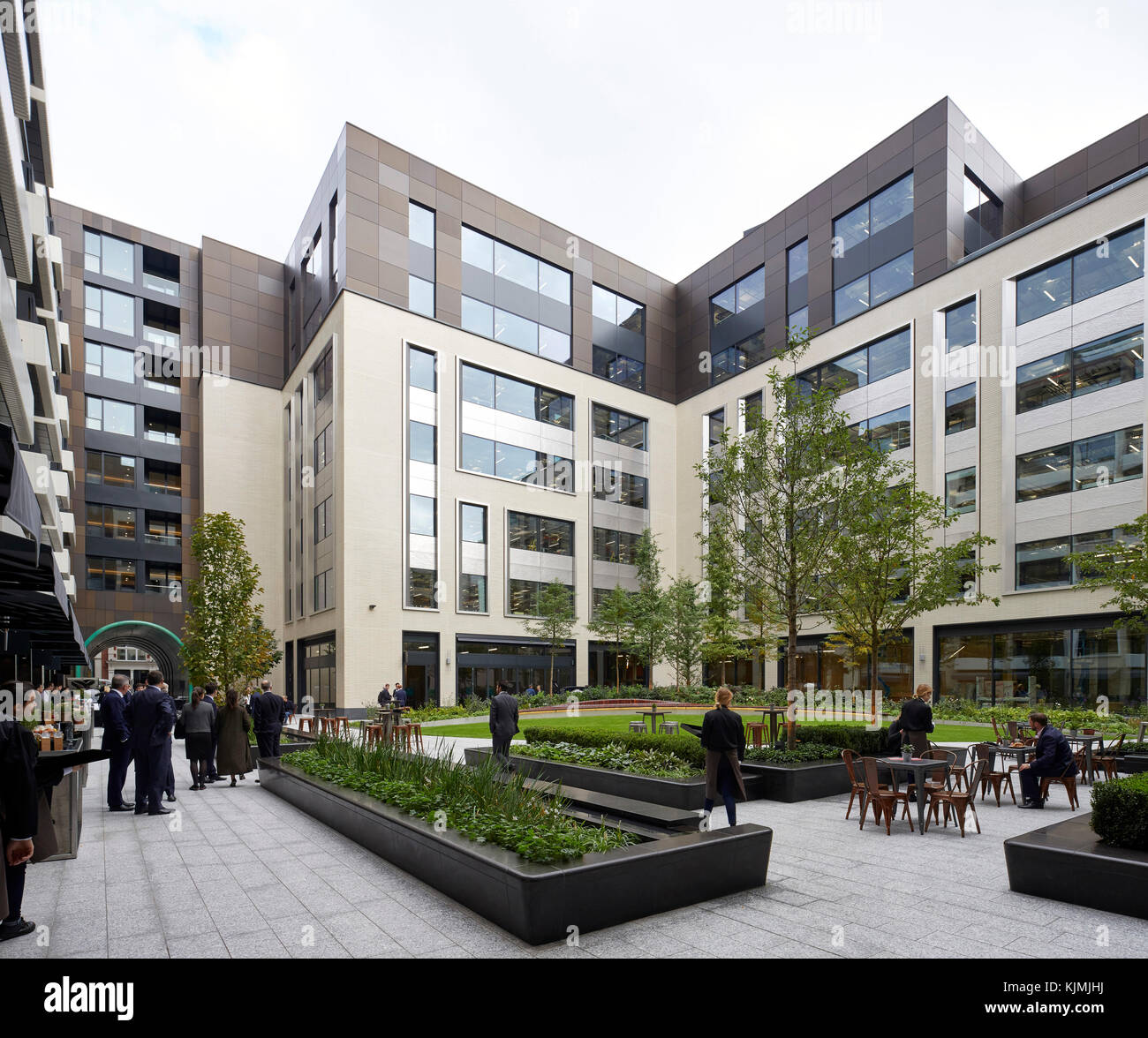 View of central courtyard with group of people attending opening event ...