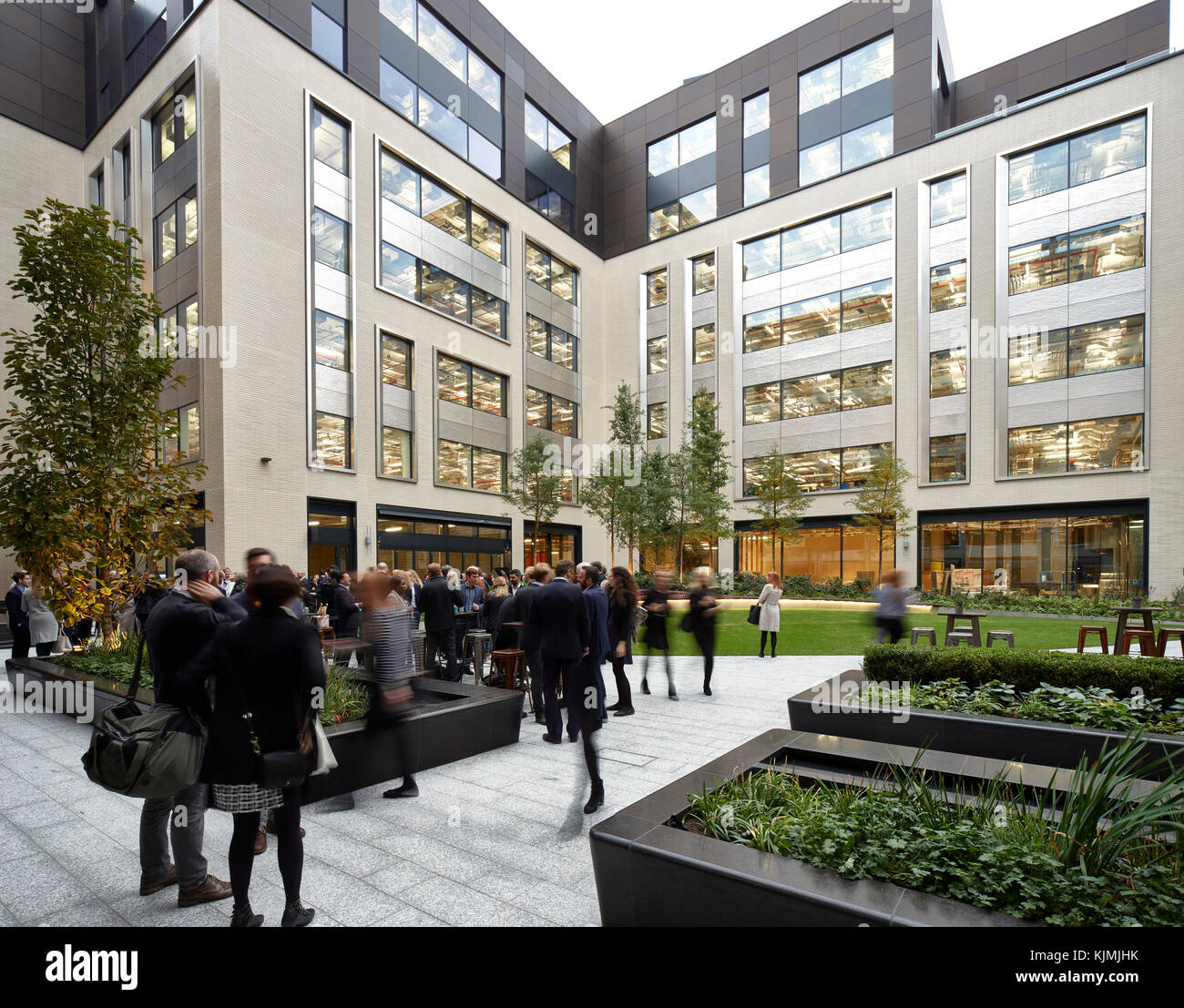 View of central courtyard with group of people attending opening event ...